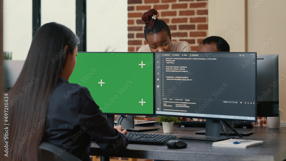 Software Developer Writing Algorithm In Front Of Computer With Green