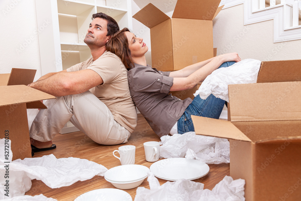 Tired Exhausted Couple Unpacking Or Packing Boxes Moving House Stock