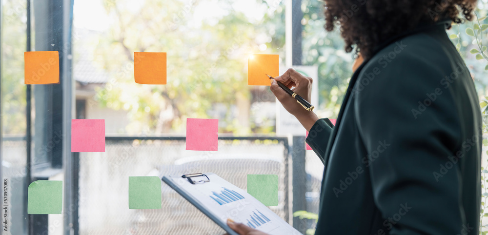 Attractive Concentrated Business Lady In Creating To Do List Using