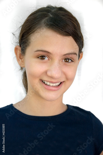 a beautiful hispanic preteen smiling at the camera Stock Photo | Adobe ...