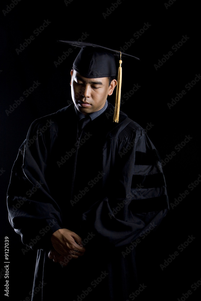 Low key image of a male model in graduation robes and regalia Stock ...