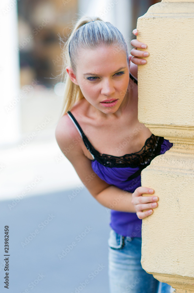 angry teen girl hiding behind corner Stock Photo | Adobe Stock