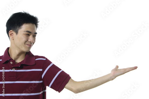 young man holding his arm out presenting something. - Buy this stock ...