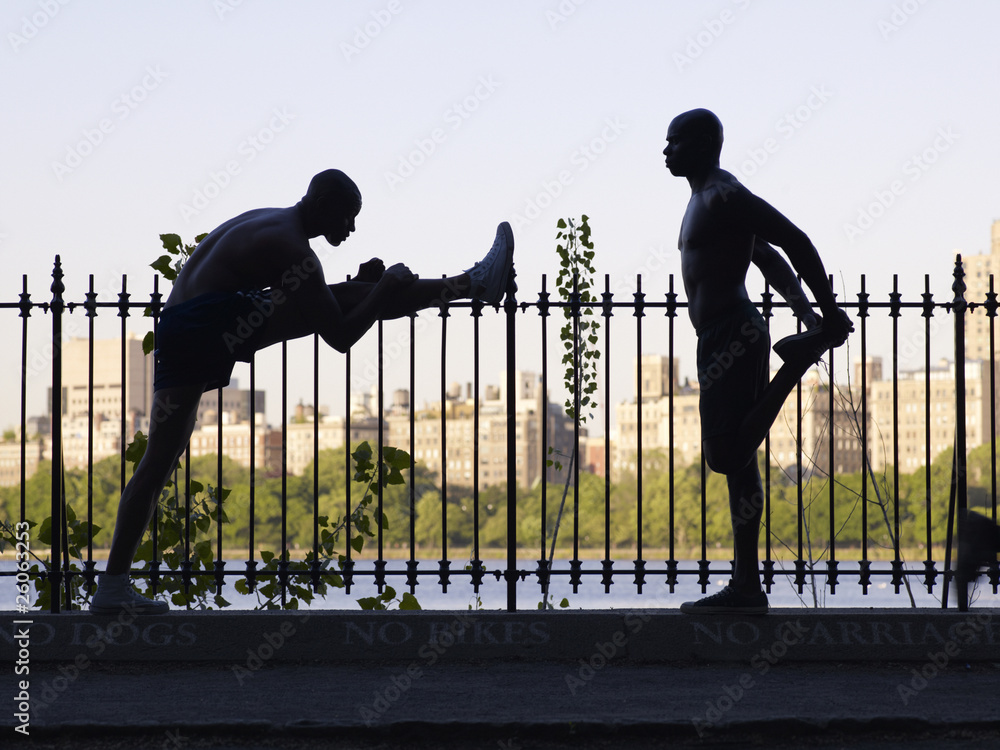African men stretching on railing Stock Photo | Adobe Stock