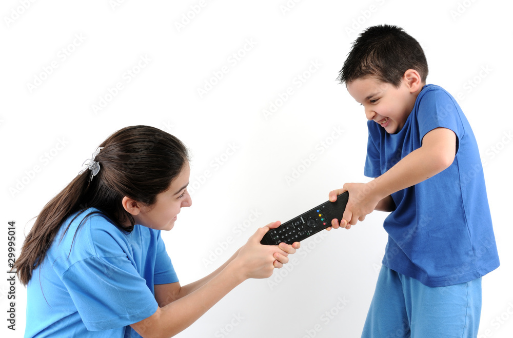 Brother and sister fighting over the TV remote control isolated. Stock ...