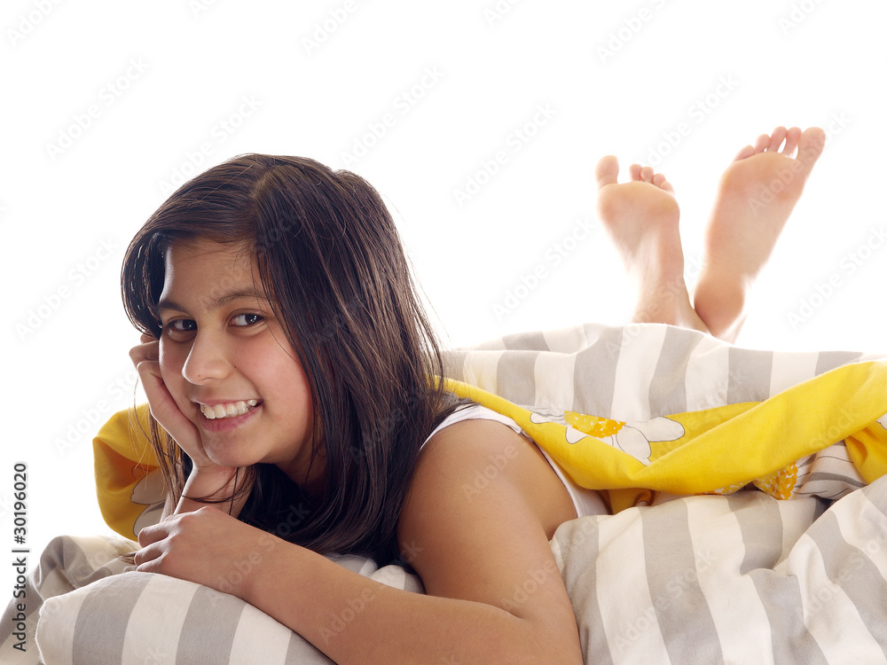 smiling girl lying in bed feet up Stock Photo | Adobe Stock