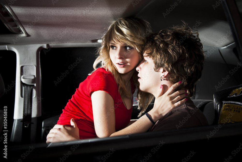 Caucasian couple making out in back seat of car Stock Photo | Adobe Stock