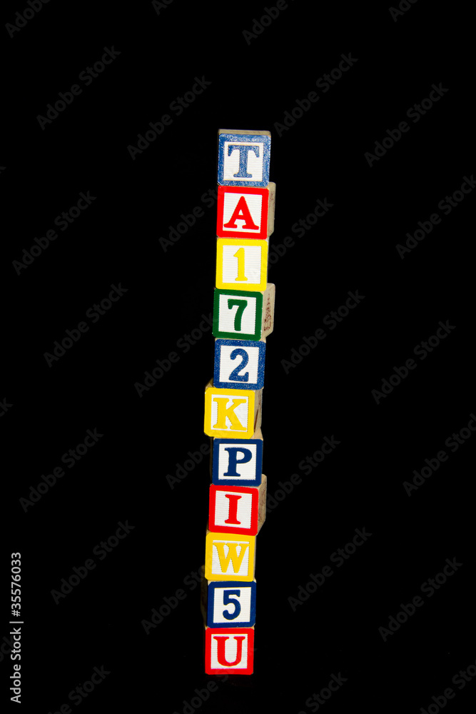 Leaning tower of Alphabet Blocks against Black の Stock フォト | Adobe Stock