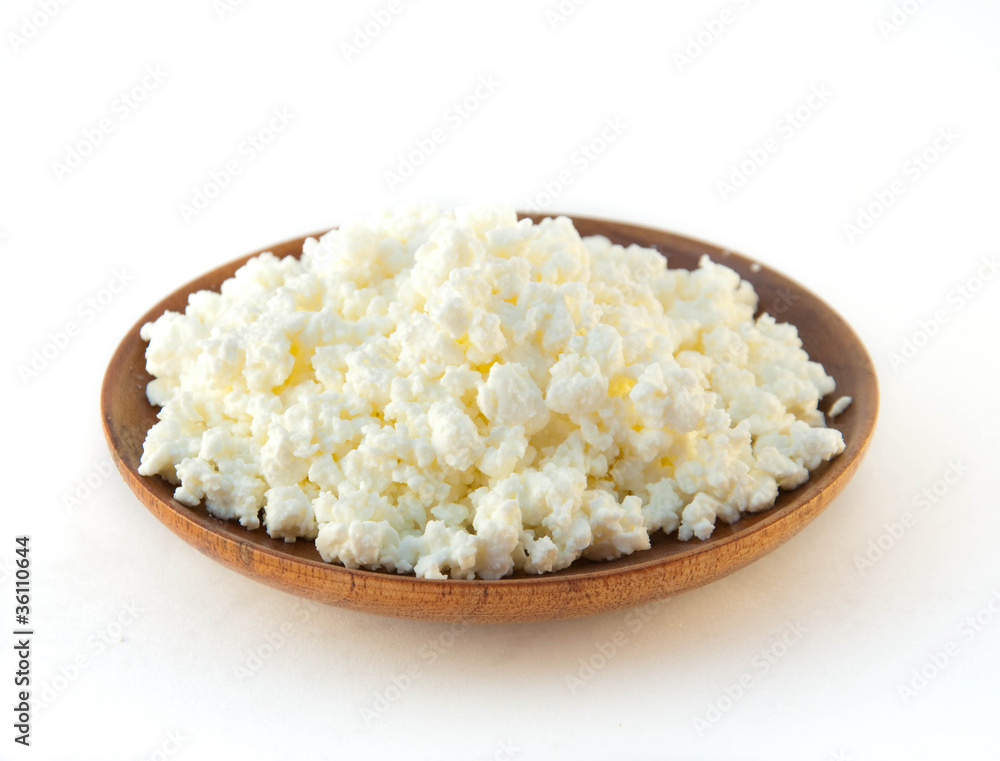 Cottage cheese from the cow milk in a wooden plate. Stock Photo | Adobe ...