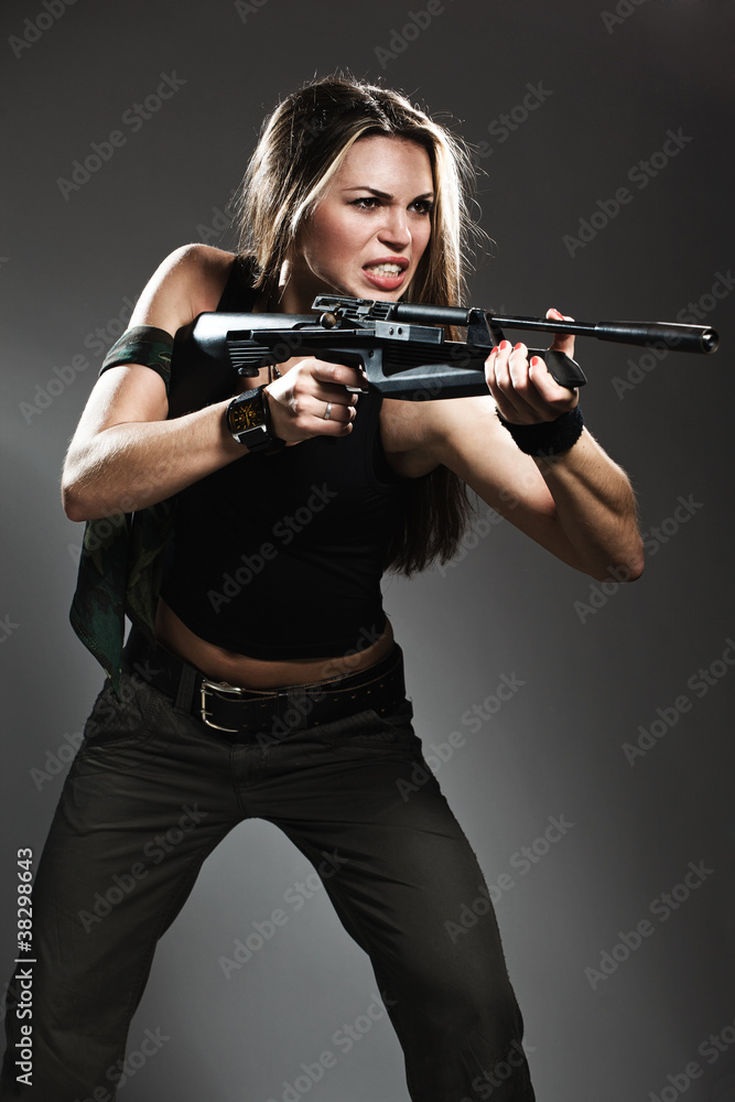 Sexy woman with rifle on dark Stock Photo | Adobe Stock