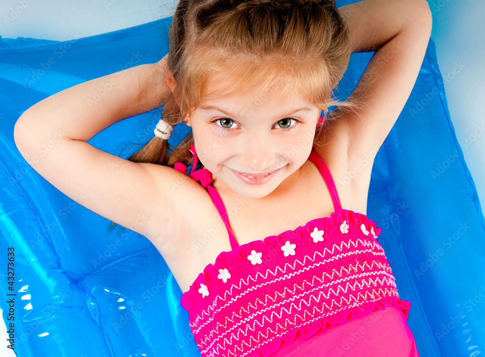 cute little girl in a swimming suit on an inflatable mattress Stock ...