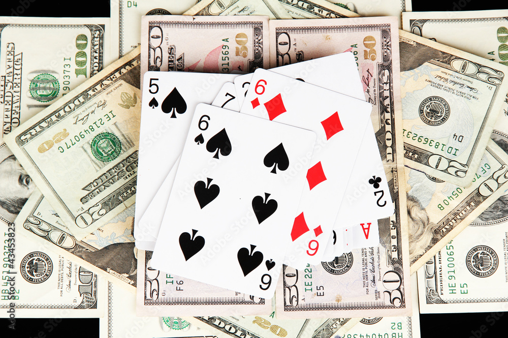 Dollars and a deck of playing cards on black background Stock Photo ...