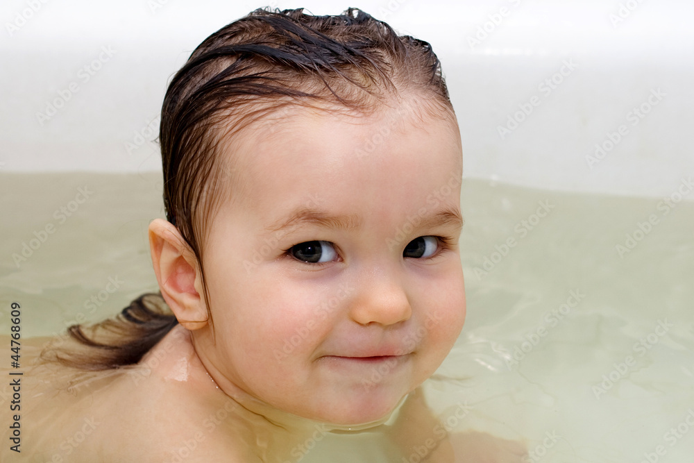 Baby with wet hair swimming in bathtub. Face close-up. Stock Photo ...