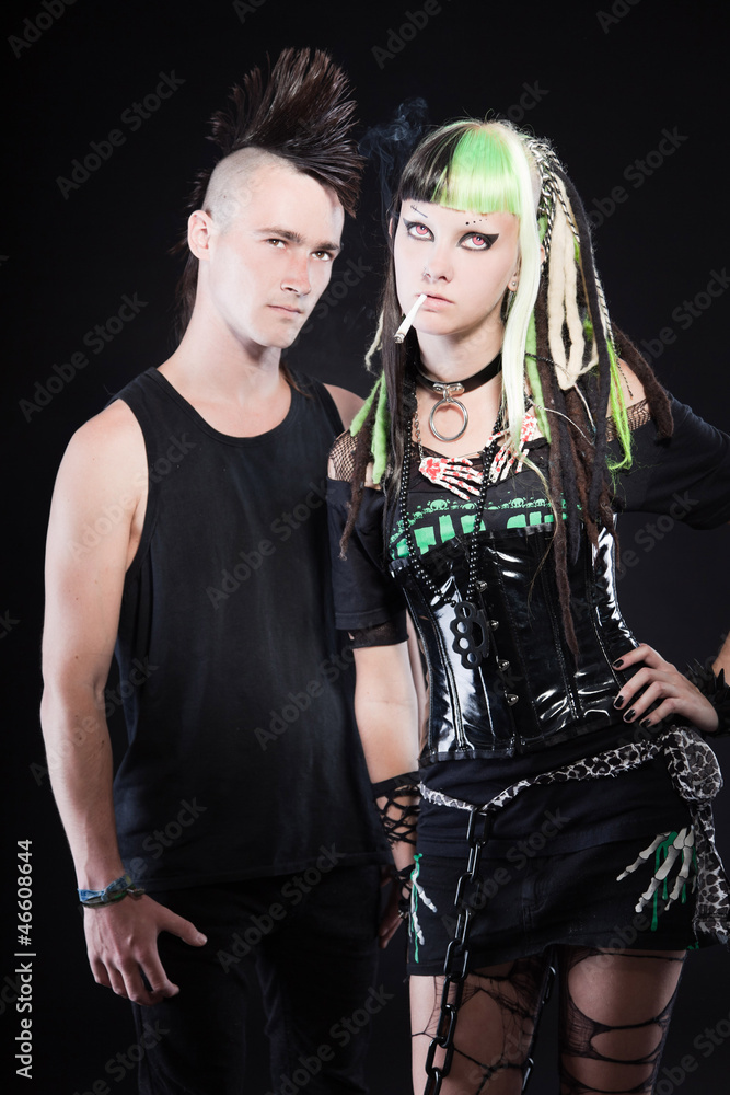 Foto de Stock Couple of cyber punk girl punk rock man smoking a ...
