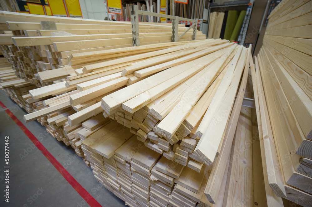 Lumber boards and beams of different sizes lie on racks and pall Stock ...