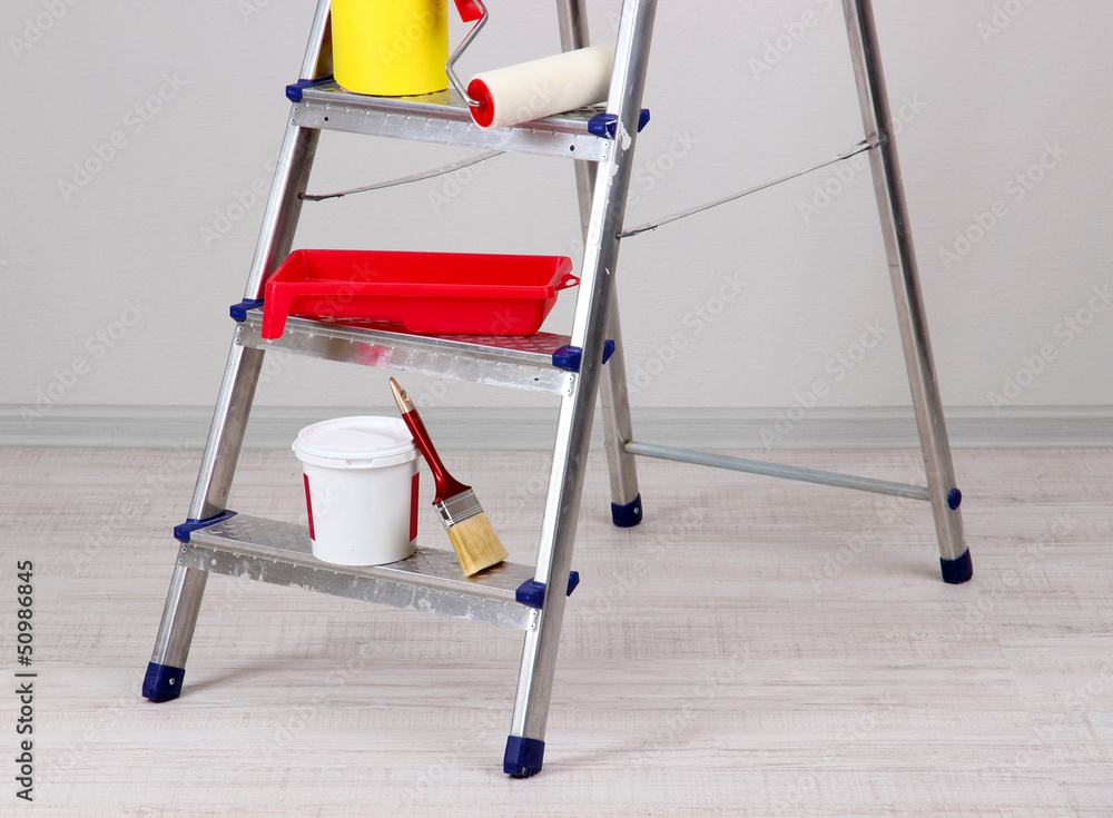 Metal ladder and paint in room Stock Photo | Adobe Stock