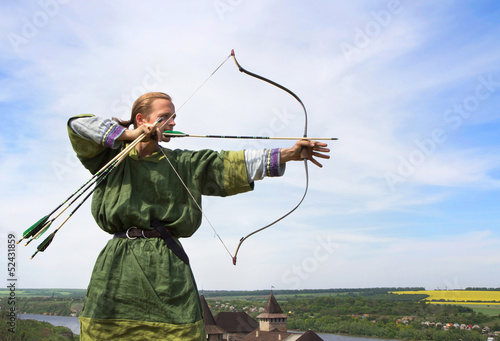 Young archer with bow and arrows in medieval costume aiming Stock Photo ...