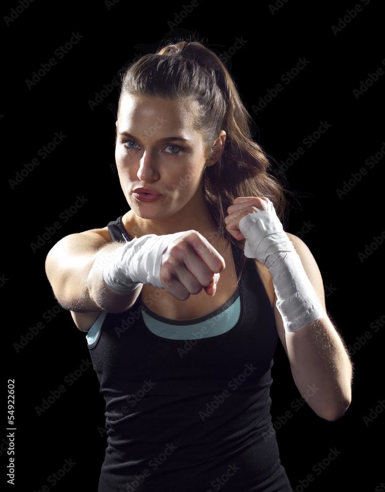 female MMA fighter punching. black background Stock Photo | Adobe Stock