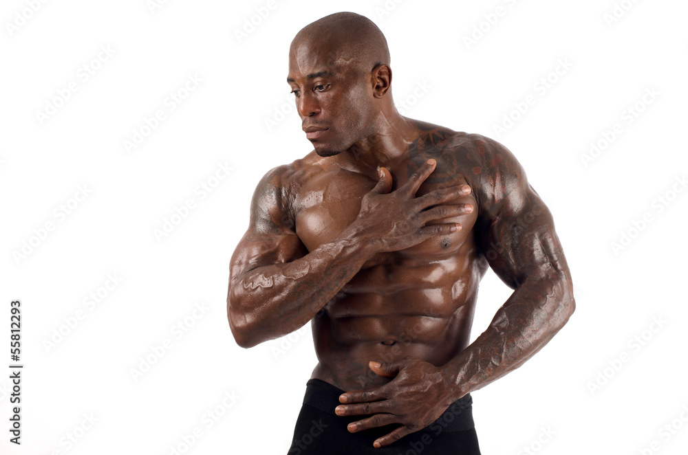 Black bodybuilder pouring oil on his muscles. Strong man Stock Photo ...