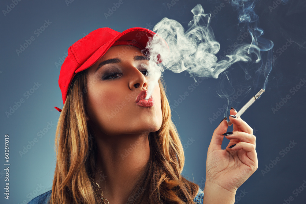 Beautiful young woman smoking cigarette Stock Photo | Adobe Stock
