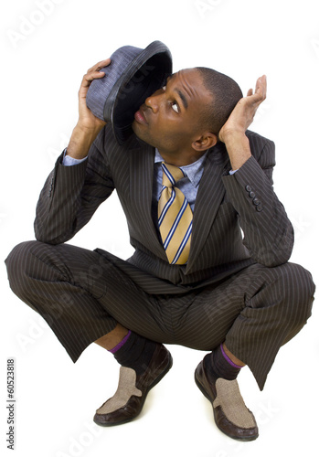 young black businessman ducking from unseen threat - Buy this stock ...