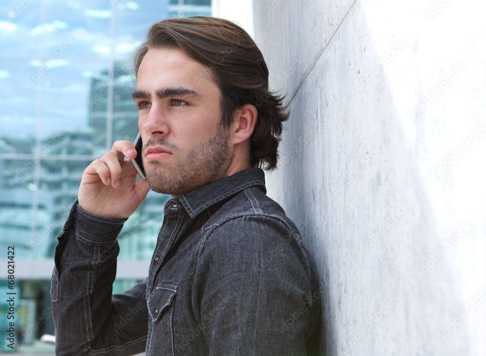 Stock-Foto „Young man calling by cellphone“ | Adobe Stock