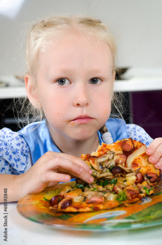 Starving young girl eating Stock Photo | Adobe Stock