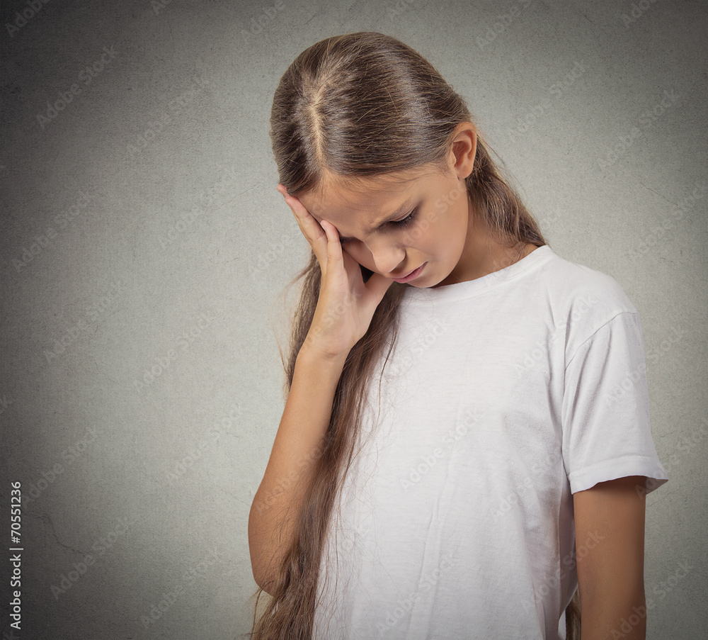 depressed disappointed child resting face on hand looking down の Stock ...