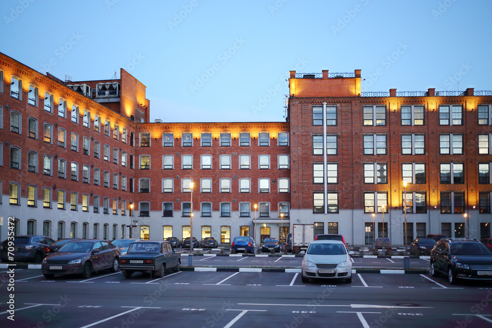 Car parking in courtyard of building built of red bricks Stock Photo ...