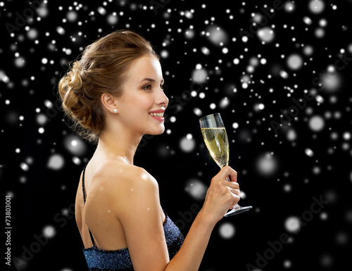 smiling woman holding glass of sparkling wine Stock Photo | Adobe Stock smiling woman holding glass of sparkling wine Stock Photo | Adobe Stock