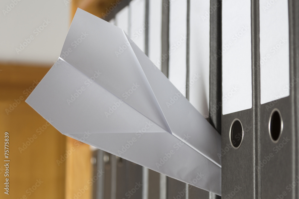 Paper Plane stuck between folders Stock Photo | Adobe Stock