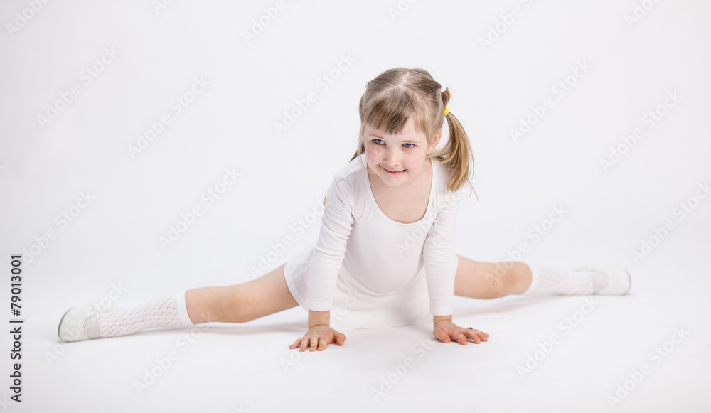 Smiling little girl doing the splits Stock Photo | Adobe Stock