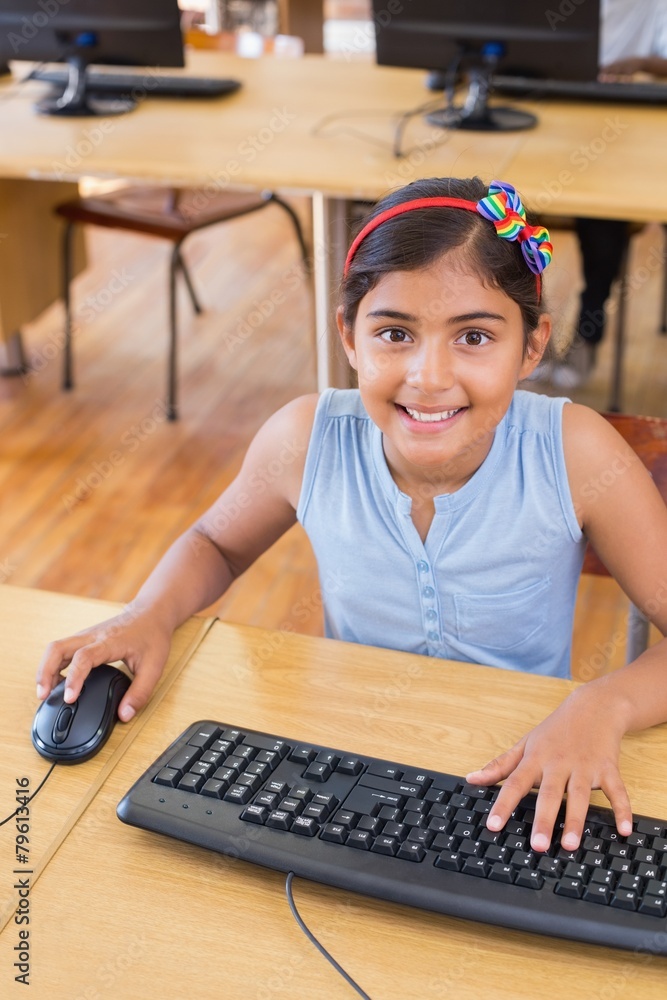 Cute pupil in computer class Stock Photo | Adobe Stock