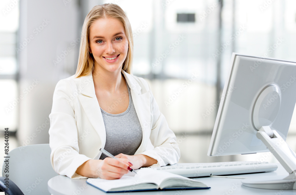 Young business woman using computer at office Stock Photo | Adobe Stock