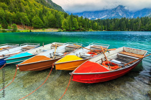 Stunning alpine landscape and colorful boats,Lake Fusine,Italy Stock ...