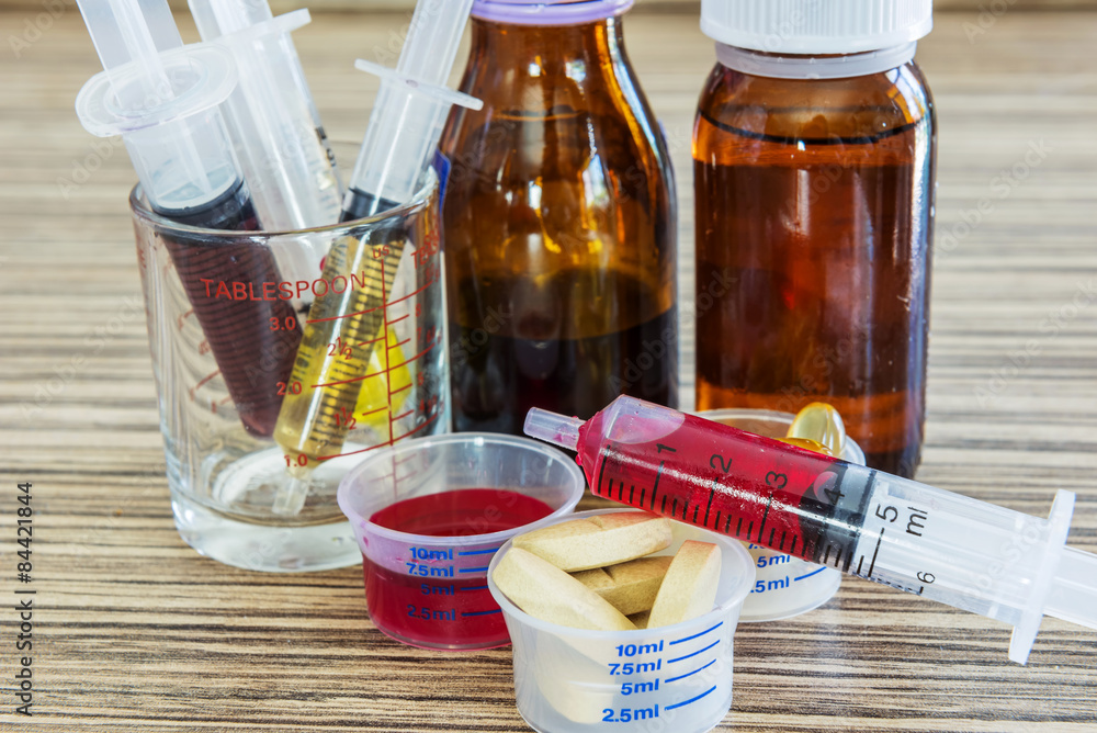 Syringe with syrup medicine and pill use to feed for kids. Stock Photo ...