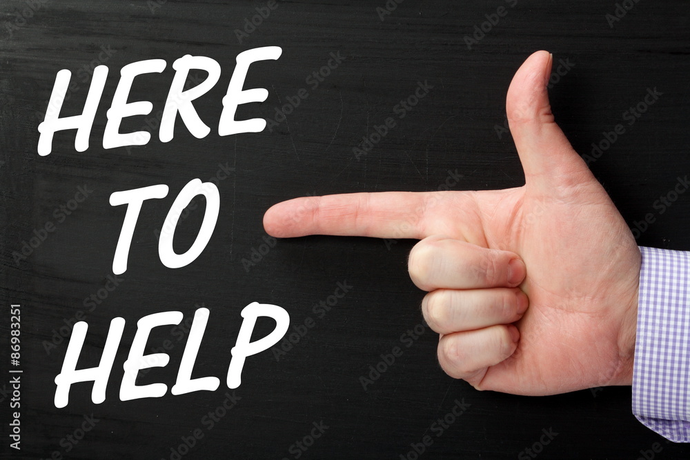 Hand pointing a finger at the phrase Here to Help in white text on a ...