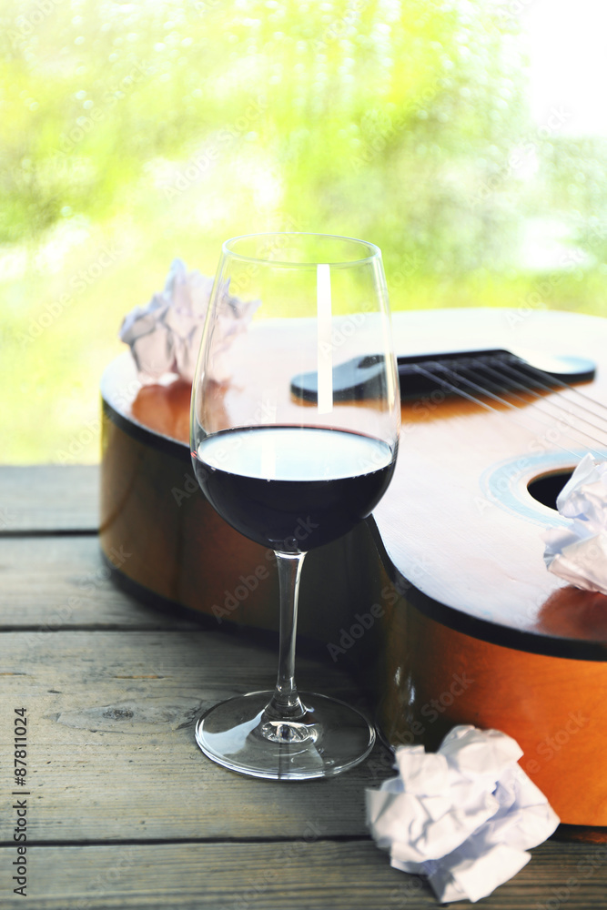 Acoustic guitar and glass of wine next the window with rain drops Stock ...