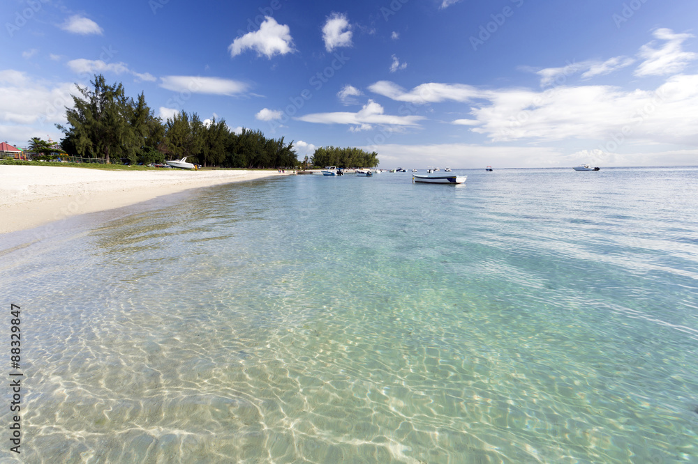 View along Flic en Flac Beach showing the clear shallows of the Indian ...