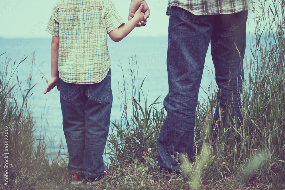 Stock-Foto „Father and son playing at the park near lake at the day ...