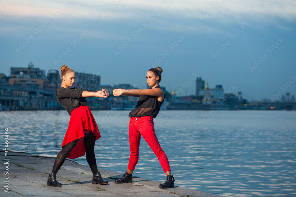 Photo Stock Two young beautiful twin sisters are dancing waacking dance ...
