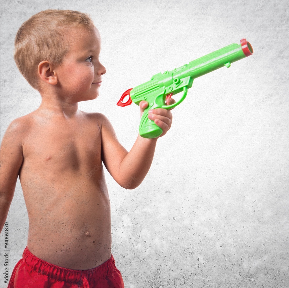 Kid holding plastic gun Stock Photo | Adobe Stock
