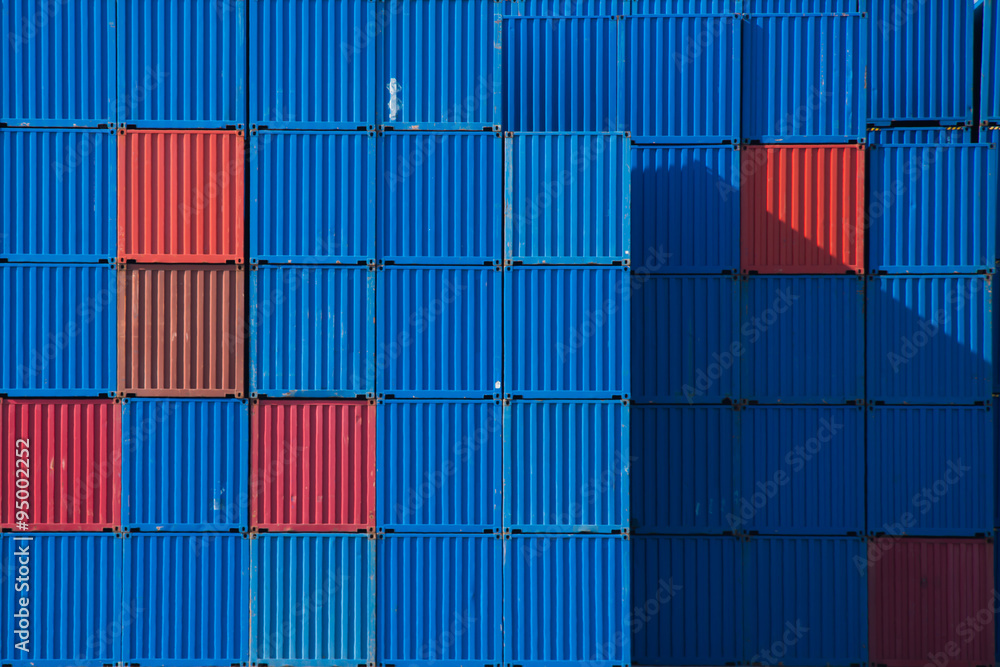 Full frame close up of stacked blue and red shipping containers in a ...