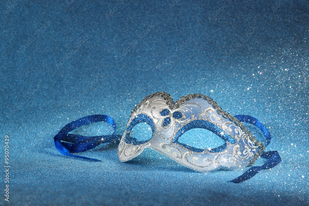 blue female carnival mask and glitter background. with glitter overlay ...