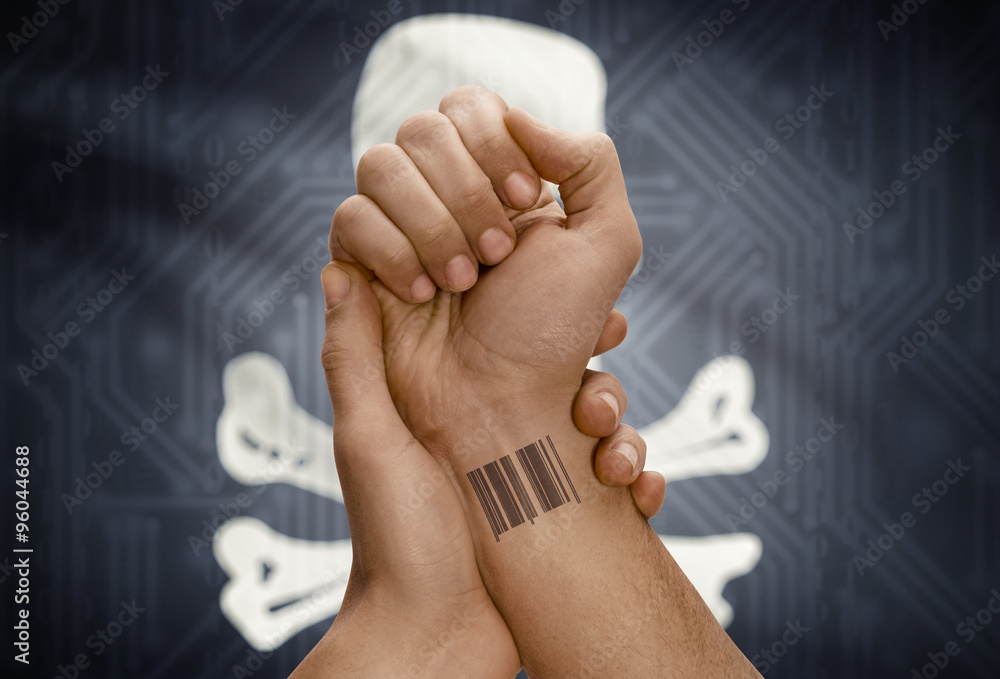Barcode ID number on wrist of dark skinned person and flag on ...