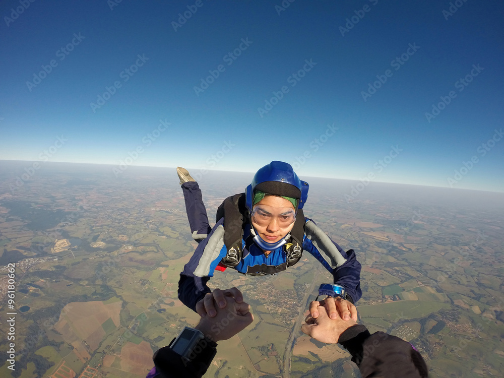 Skydiving couple holding hands Stock Photo | Adobe Stock