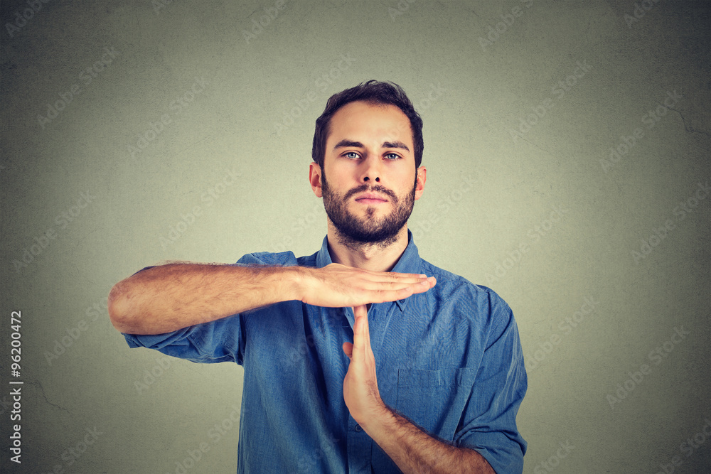 Young man giving showing time out hands gesture Stock Photo | Adobe Stock