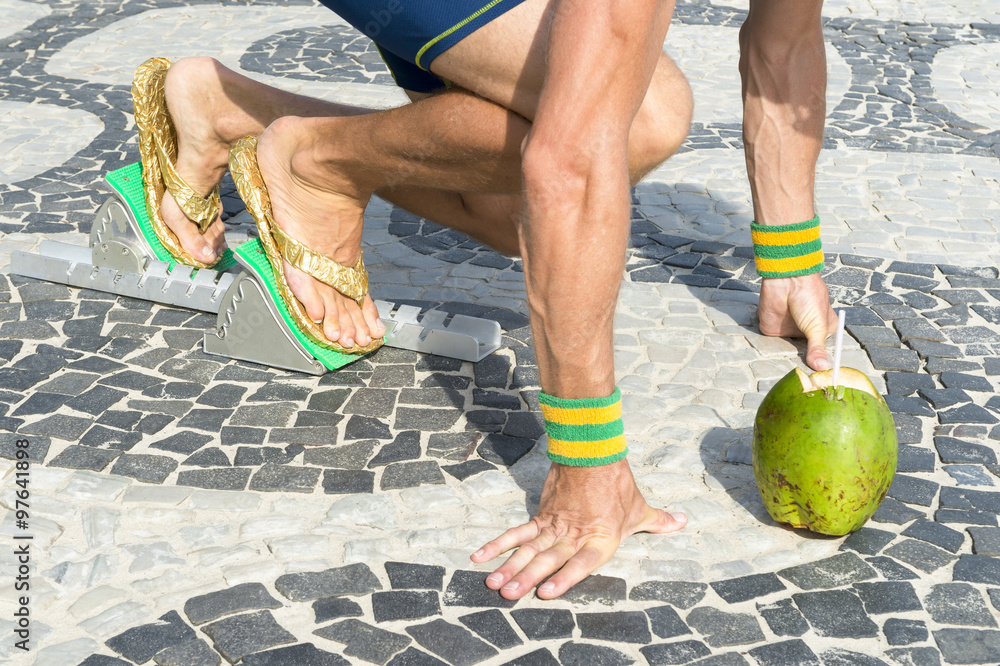 Brazilian athlete wearing flip flops crouching at the start position in ...