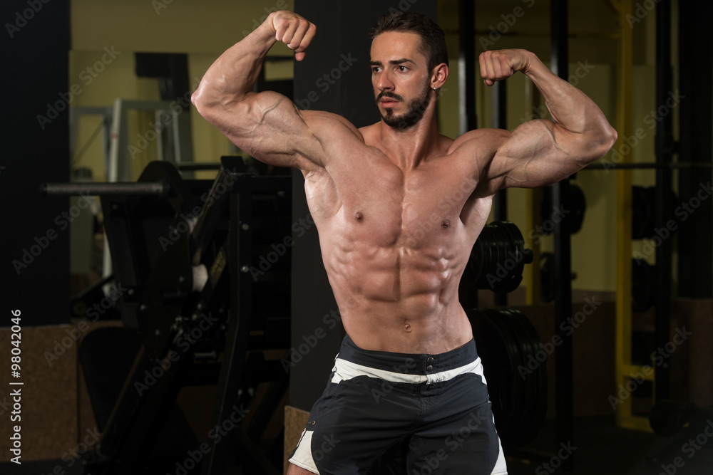 Muscular Men Is Hitting Rear Double Bicep Pose Stock Photo | Adobe Stock