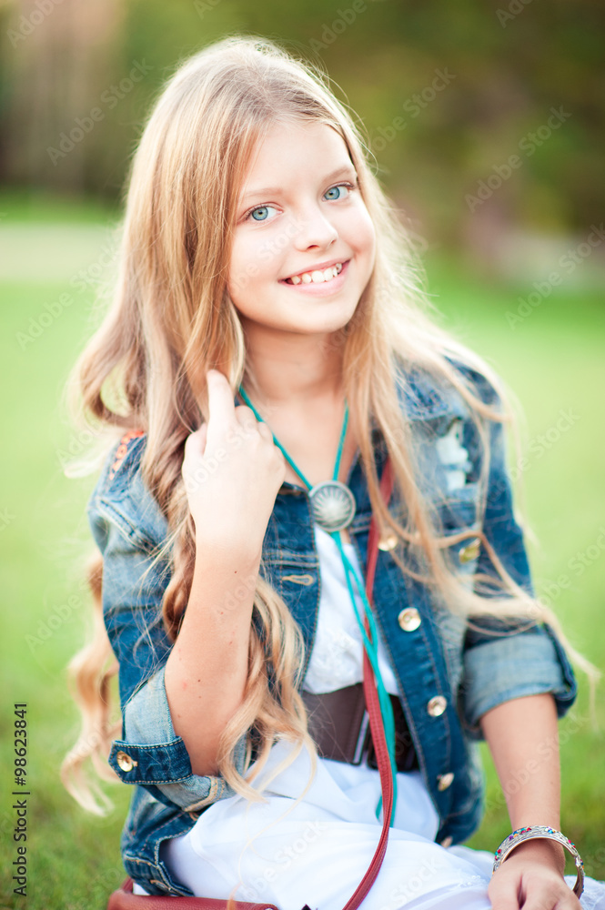 Smiling blonde teen girl 12-15 year old wearing denim jacket and white ...
